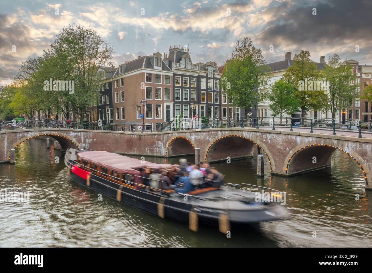 Netherlands. Summer sunset on the canals of Amsterdam. Pleasure boat ...