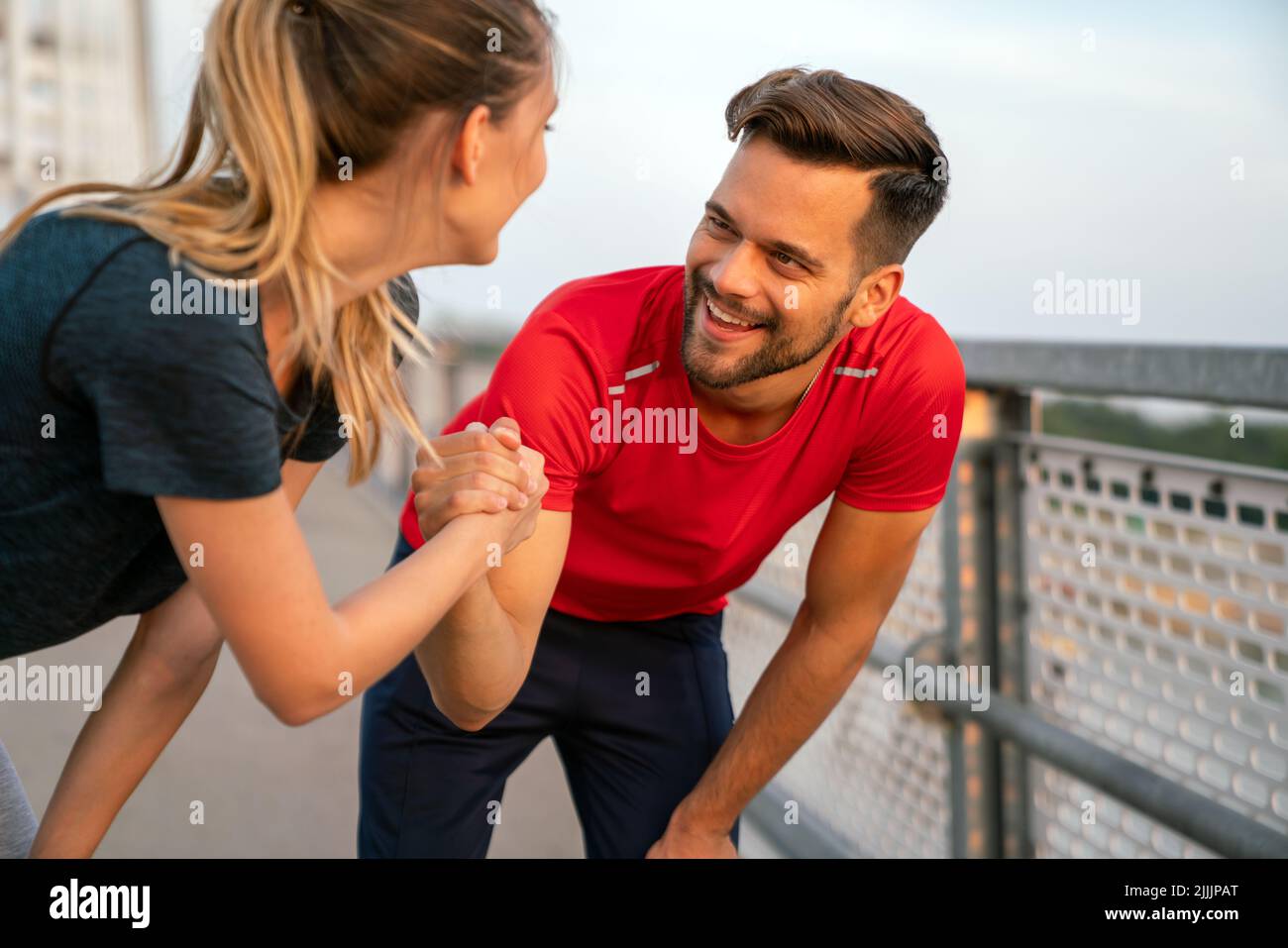 Romantic couple doing sport together on the street. Having fun after ...