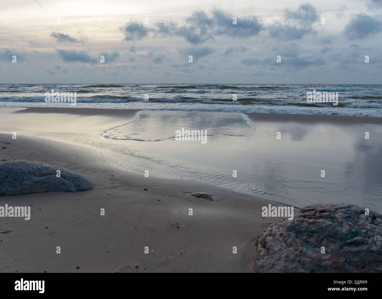landscape with sea shore, rocks in water and sand, winter, December ...
