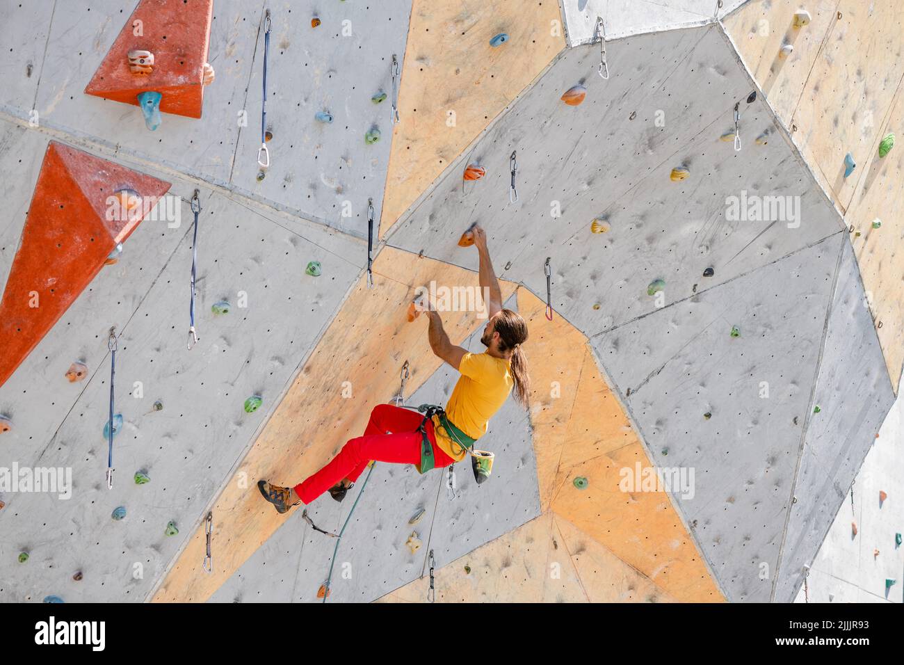 Young and fit man exercise free mountain climbing on outdoor practice ...