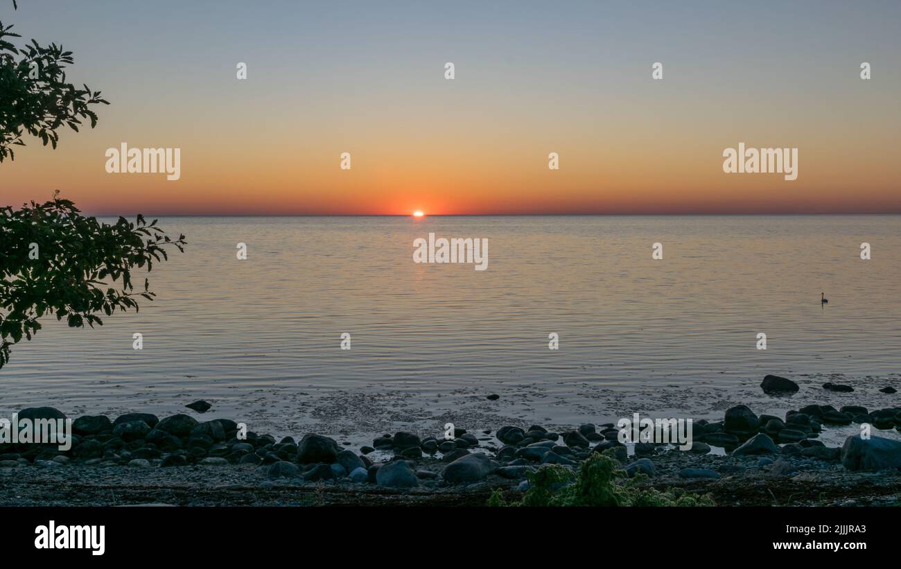 beautiful sunset landscape from a traditional rocky beach on the island ...