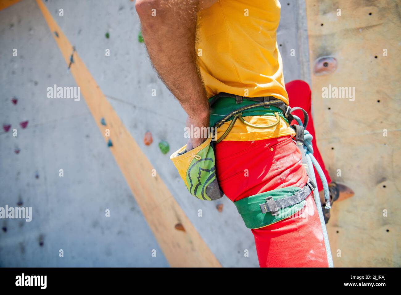 Rock climber man shoved his hands into a bag of magnesia powder behind ...