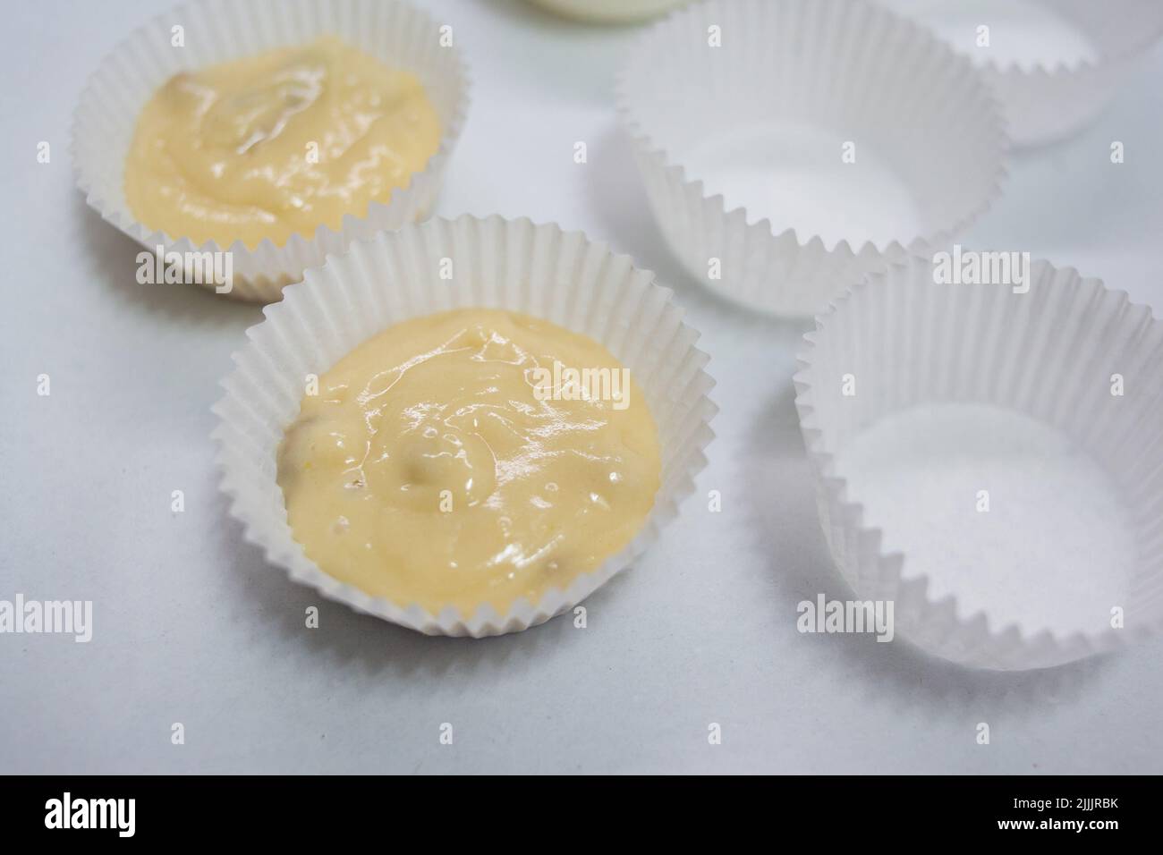 Filling paper molds dough muffins hi-res stock photography and images ...