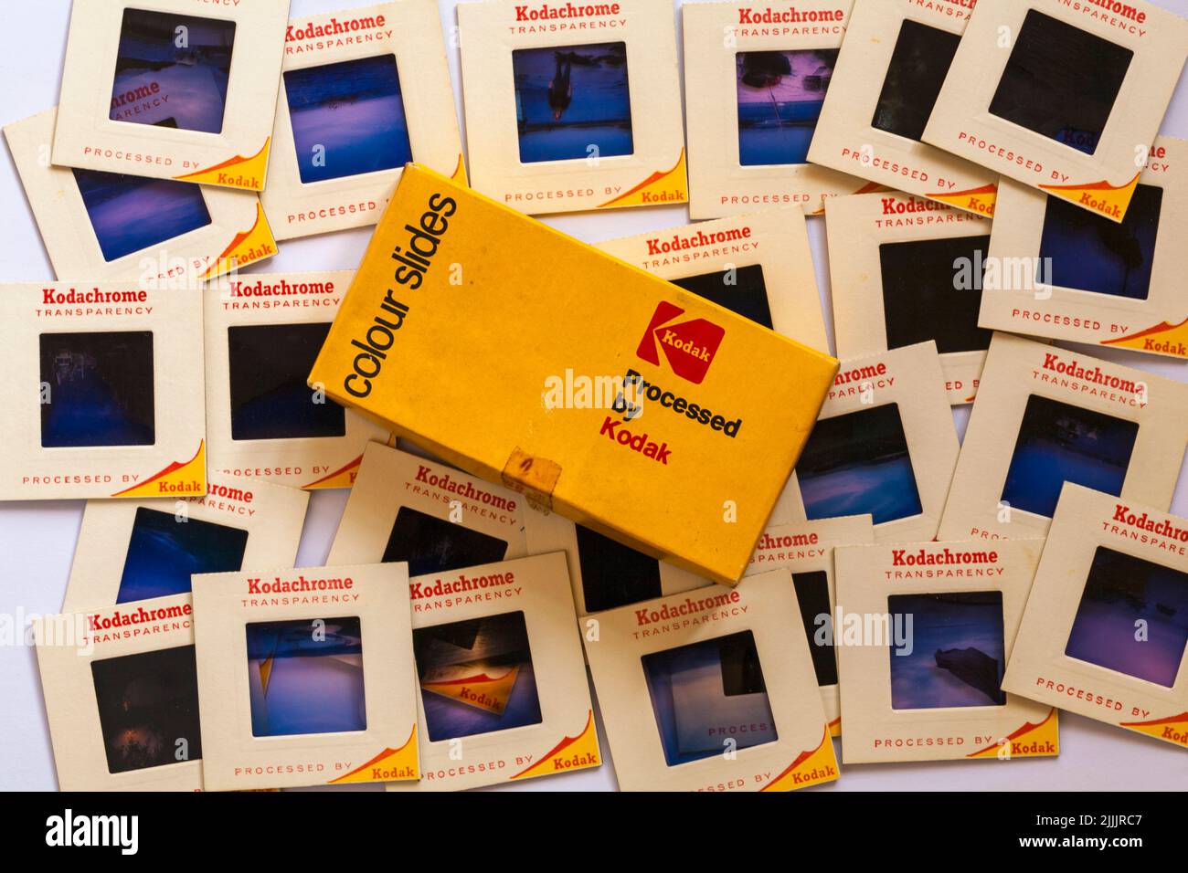 Old box of 35mm Kodak colour slides processed by Kodak with pile of ...