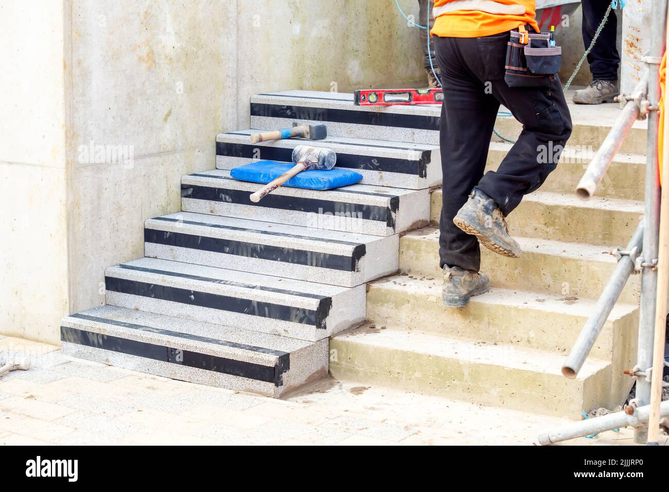 Concrete steps under construction as a team of builders install heavy ...