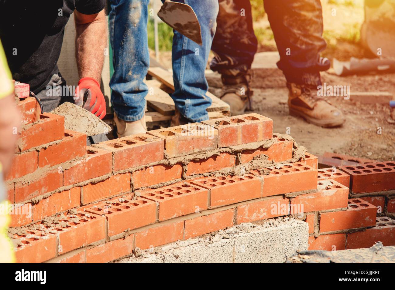 Bricklayer working on a curved wall Stock Photo - Alamy
