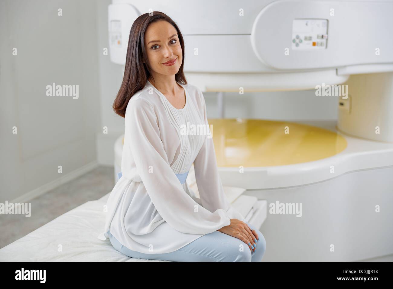 Woman patient is after doing magnetic resonance imaging MRI or CT scan ...