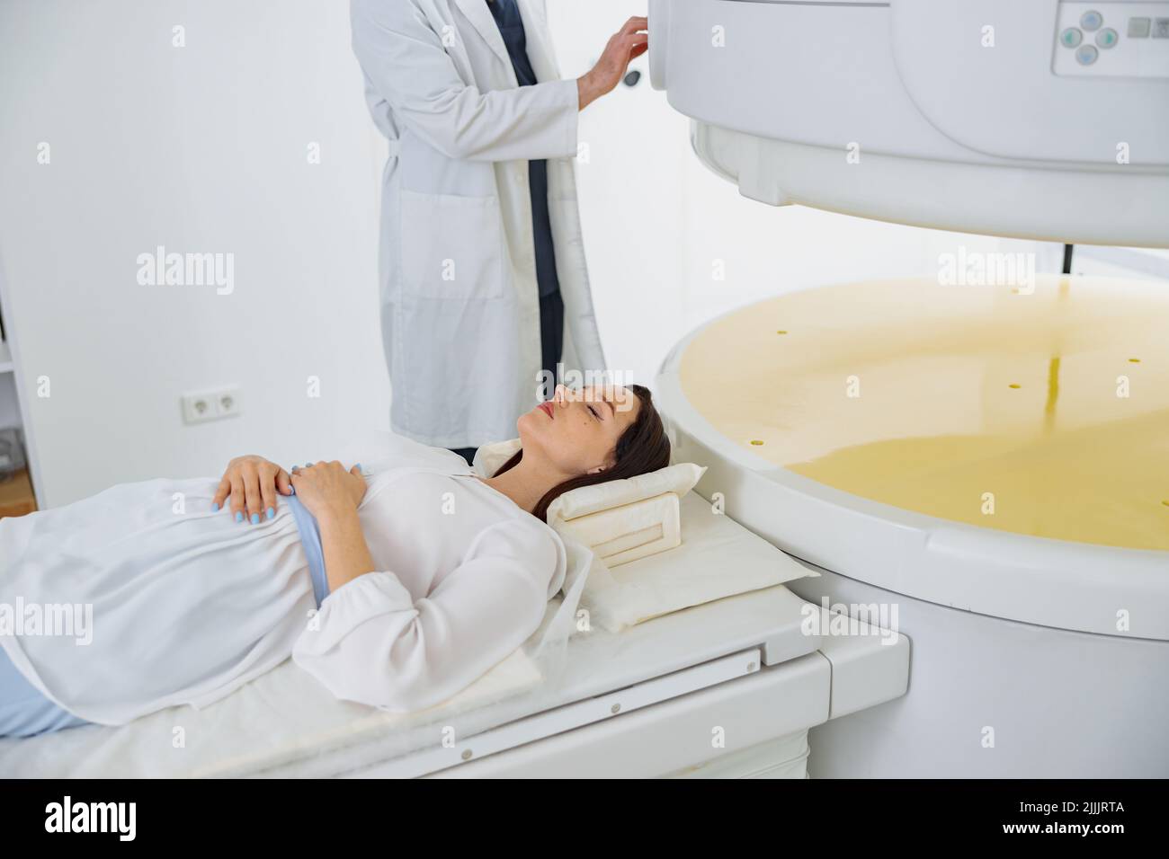 Woman patient is ready to do magnetic resonance imaging MRI or CT scan ...