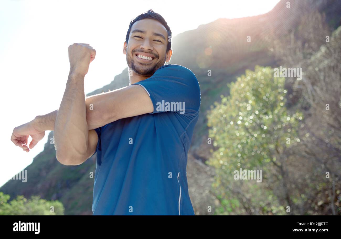 Warmups trigger adrenaline. a handsome young man standing alone and ...