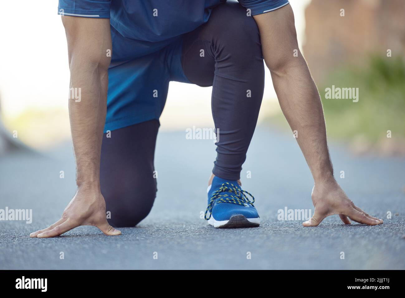 Im always ready to win. an unrecognisable man crouching down into a ...