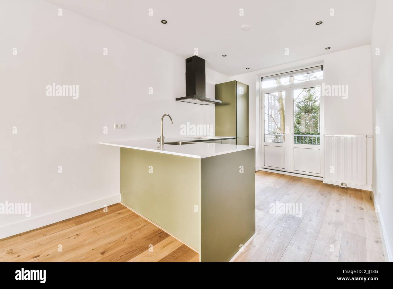Interior of empty white kitchen with windows and wooden parquet floor ...