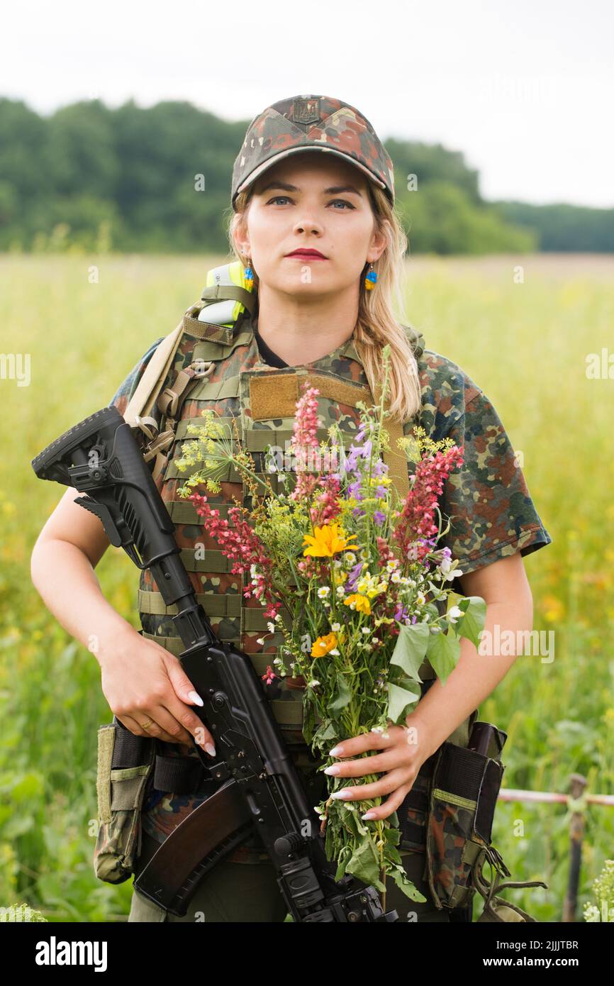 A Ukrainian soldier with a bouquet of wild flowers as a symbol of ...
