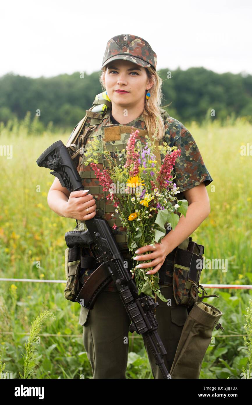 A Ukrainian soldier with a bouquet of wild flowers as a symbol of ...