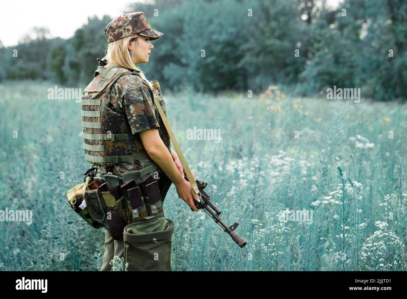 Ukrainian female military servicewoman with a machine gun in her hands ...