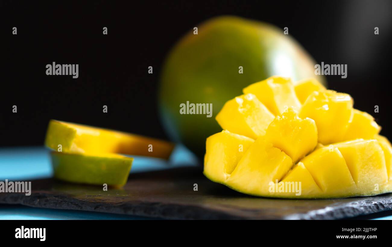 Mango cut on a dark background. Mango in home conditions not neatly cut ...