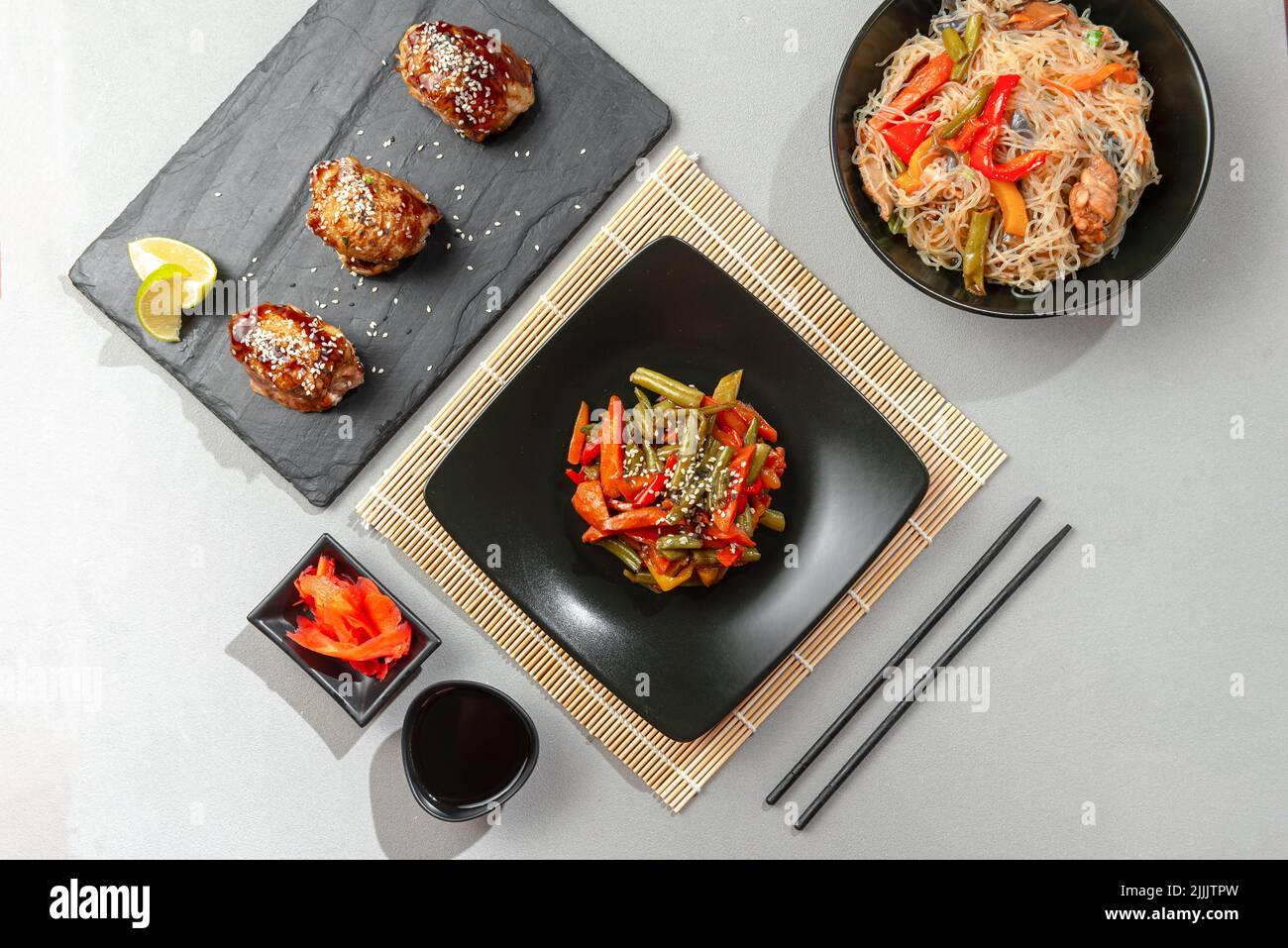 A variety of Asian food on a bright yellow background. Chinese fried ...