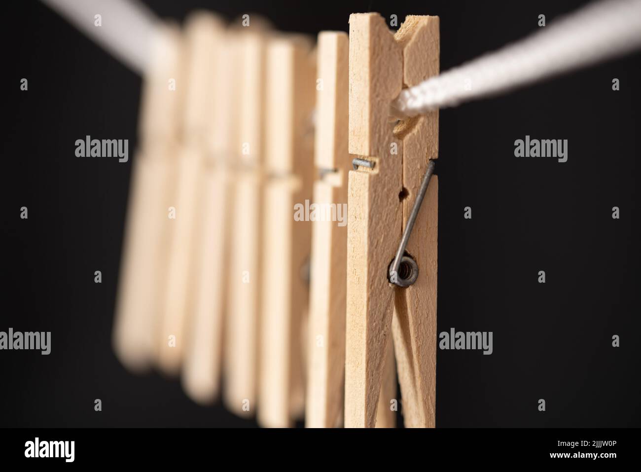 Den Helder, Netherlands. July 2022. Wooden clothes pegs on a black ...