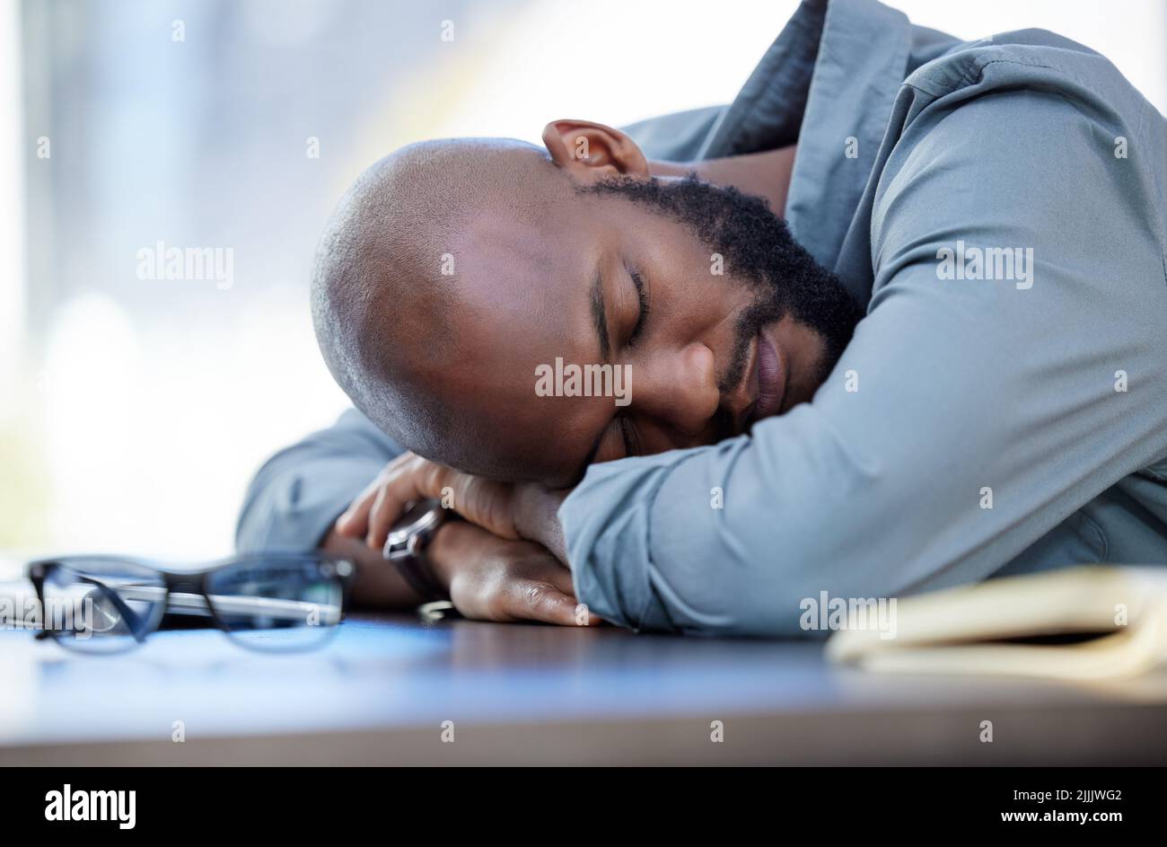 We all need some rest. a young businessman sleeping in an office at ...