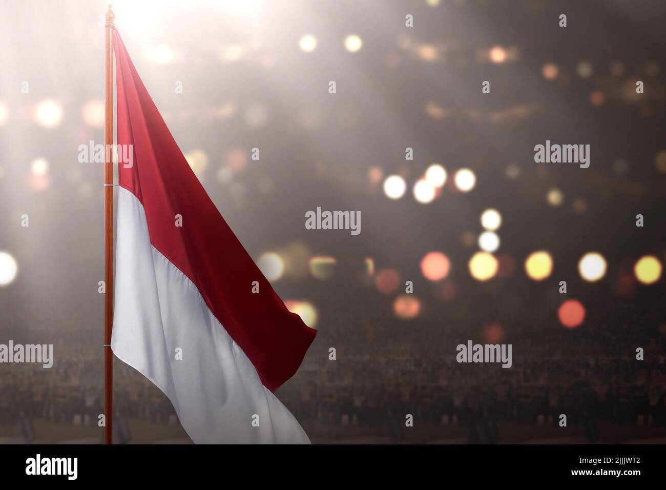 Indonesian flag on the pole waving with blurred lights background Stock ...