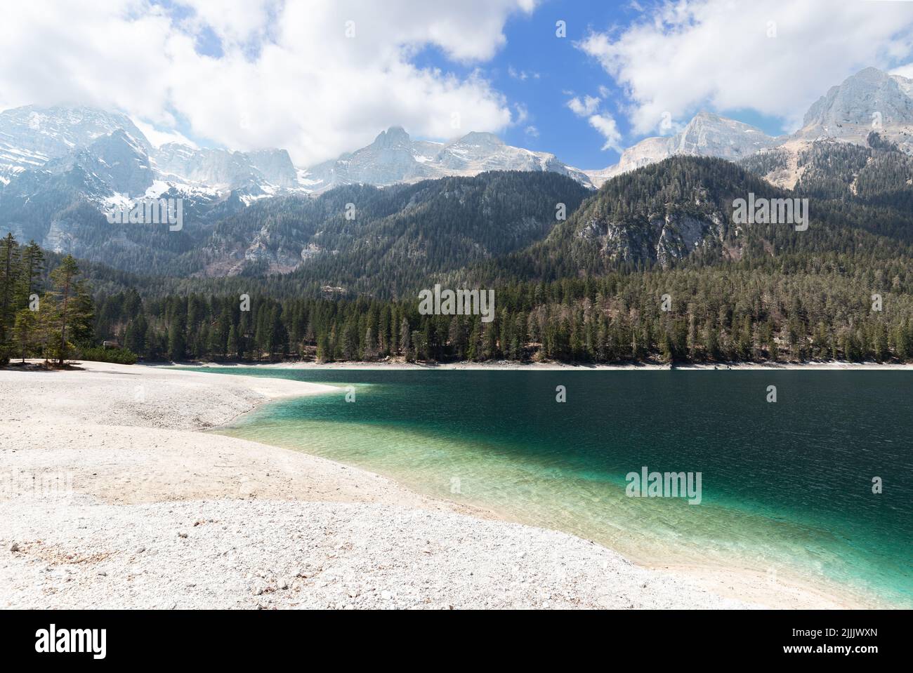 Tovel lake with emerald water and alpine mountain ranges covered with ...