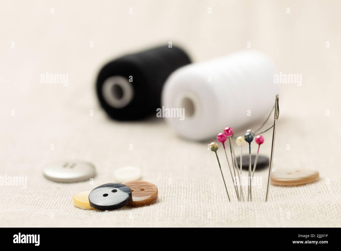 Spool of thread and needles for sewing, close-up. Skein with threads ...