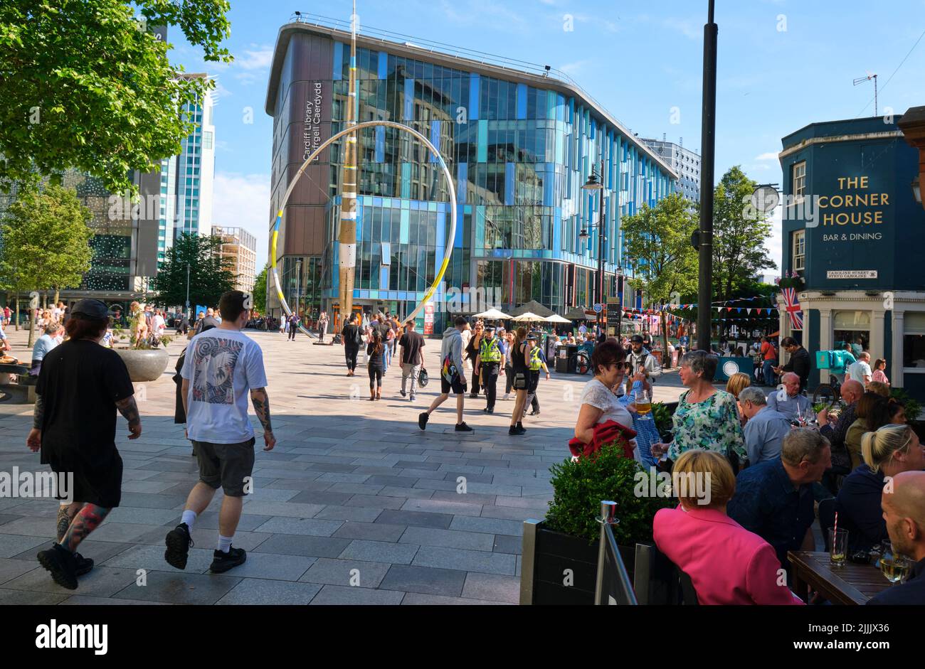 Crowds of people walking, eating, hanging out in the public plaza ...