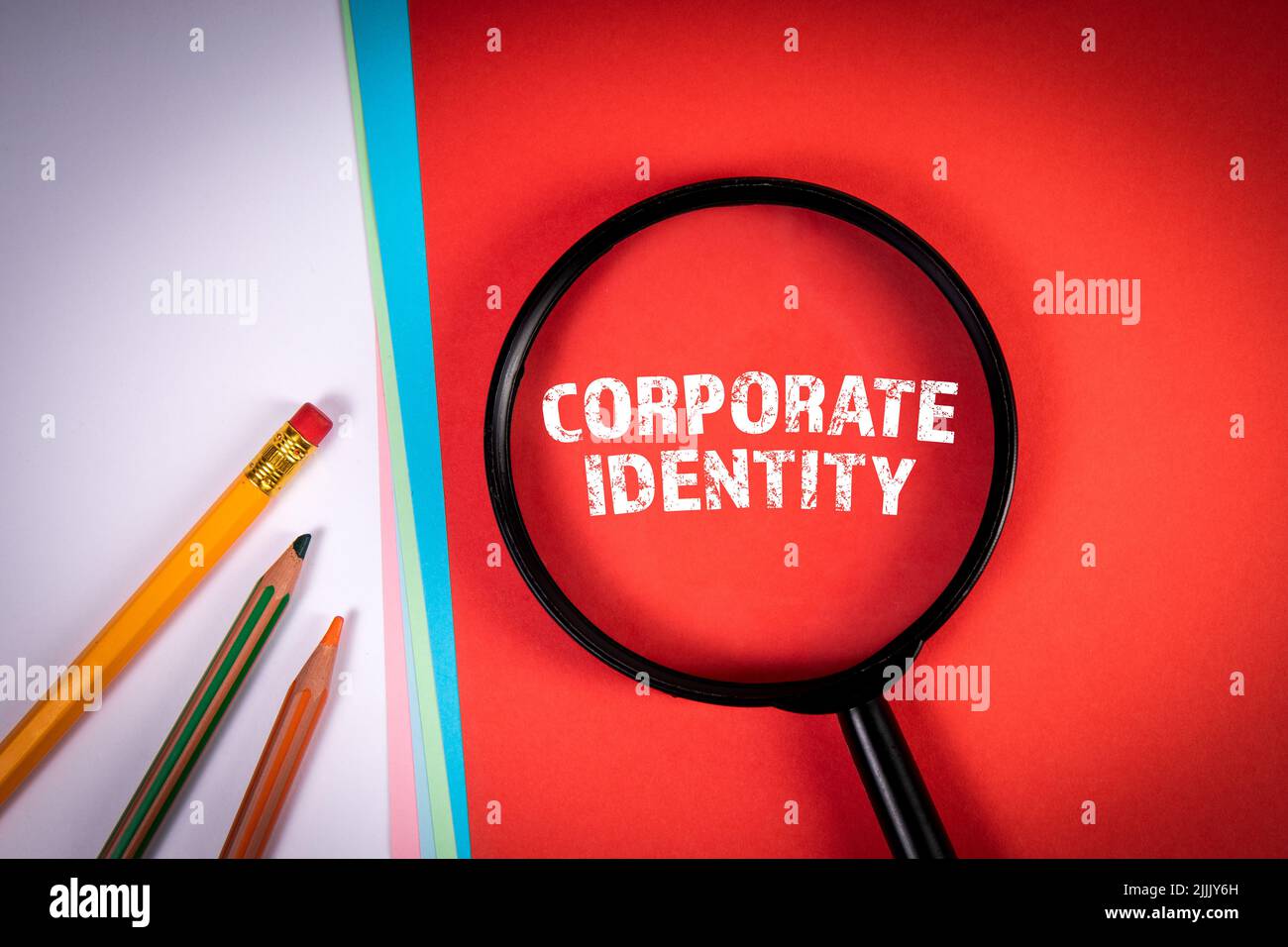 Corporate Identity. Magnifying glass and pencils on office table Stock ...