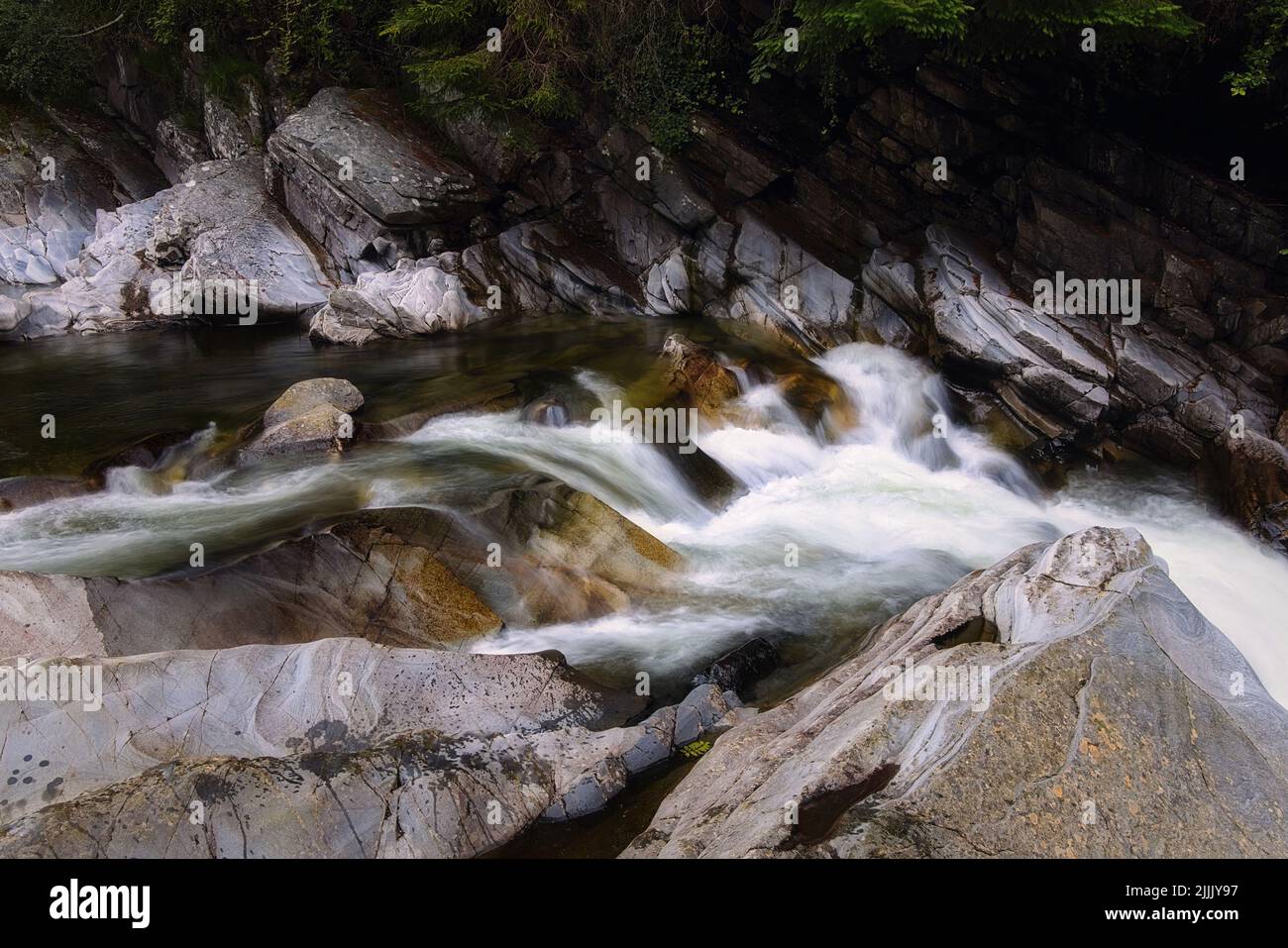 Intimate landscape: detail of the River Garry flowing around psammite ...