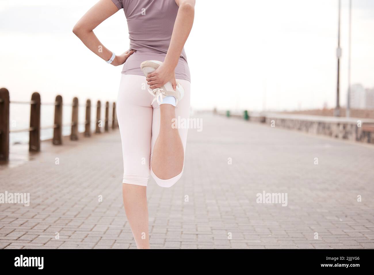 Limber muscles will get you far. an unrecognisable woman stretching ...