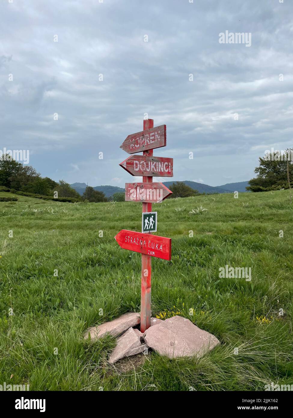 The vertical view of an old mountain hiking direction sign boards ...