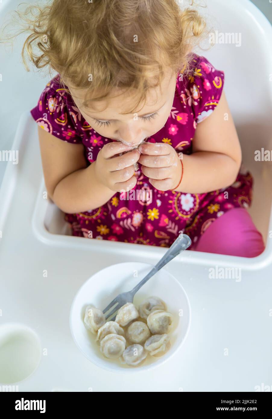 The child eats dumplings at the table. Selective focus. Kid Stock Photo ...