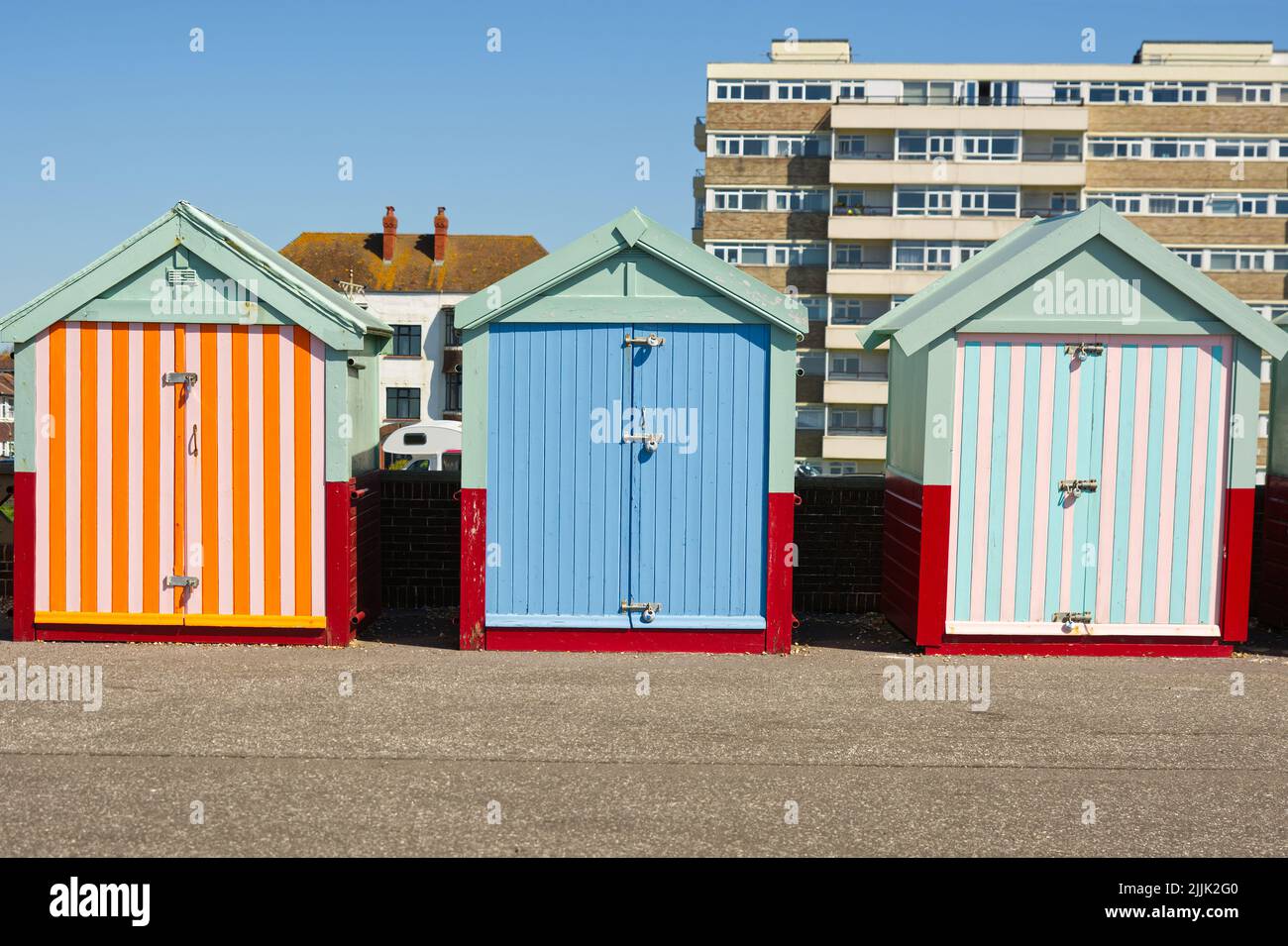 Multicoloured beach huts on the seafront promenade at Hove in Brighton ...
