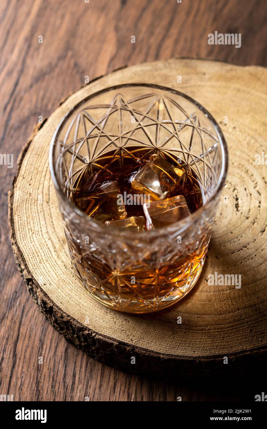 Scotch whiskey glass, on wooden table Stock Photo - Alamy
