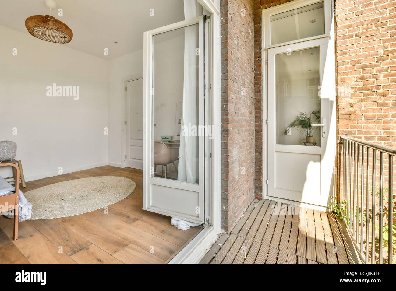 Front view of old brick buildings and from small balcony with railings ...