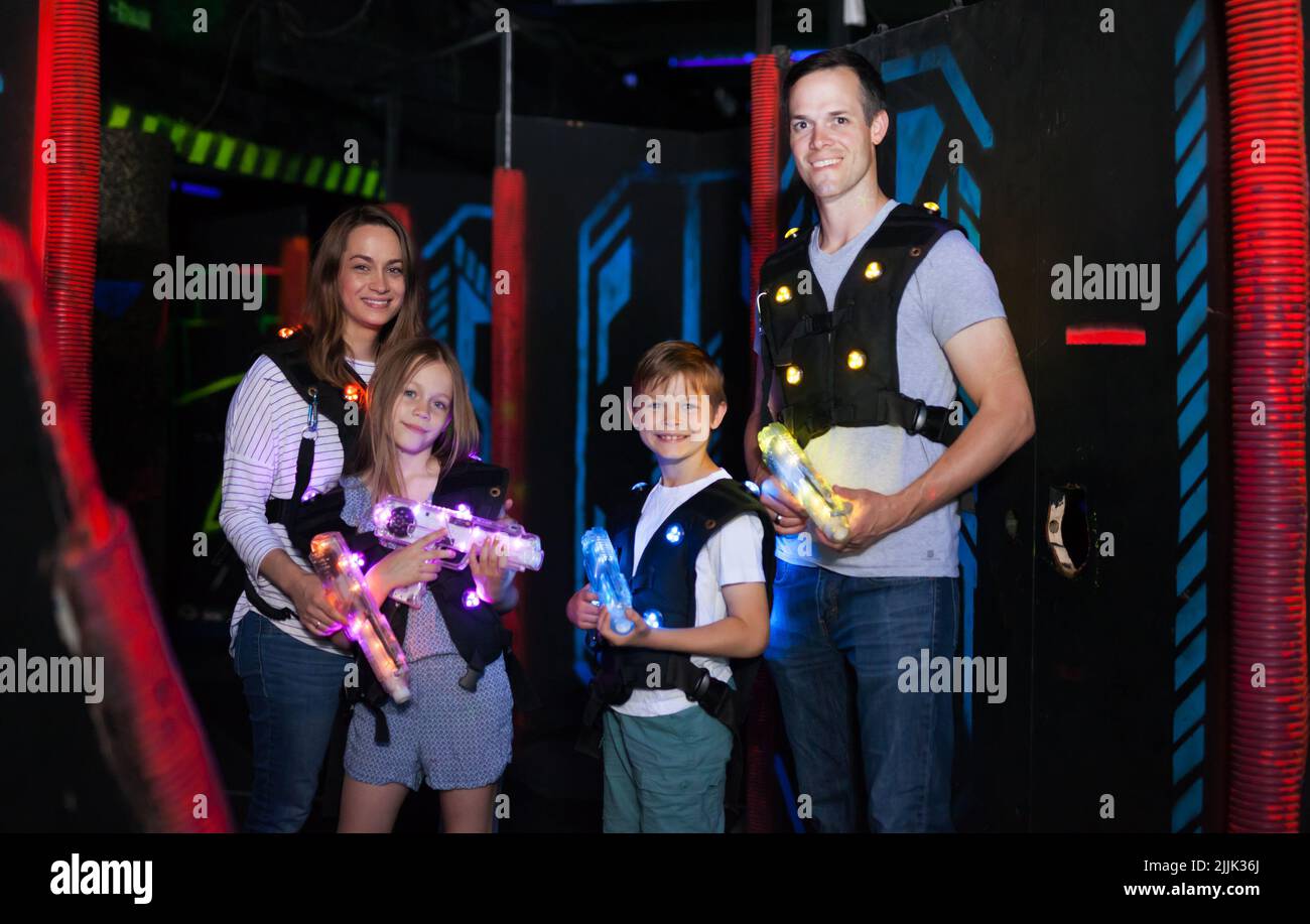 Parents and children playing laser tag Stock Photo - Alamy