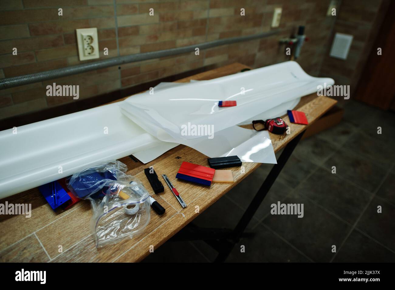 Table with items car anti gravel film at the detailing vehicle workshop ...