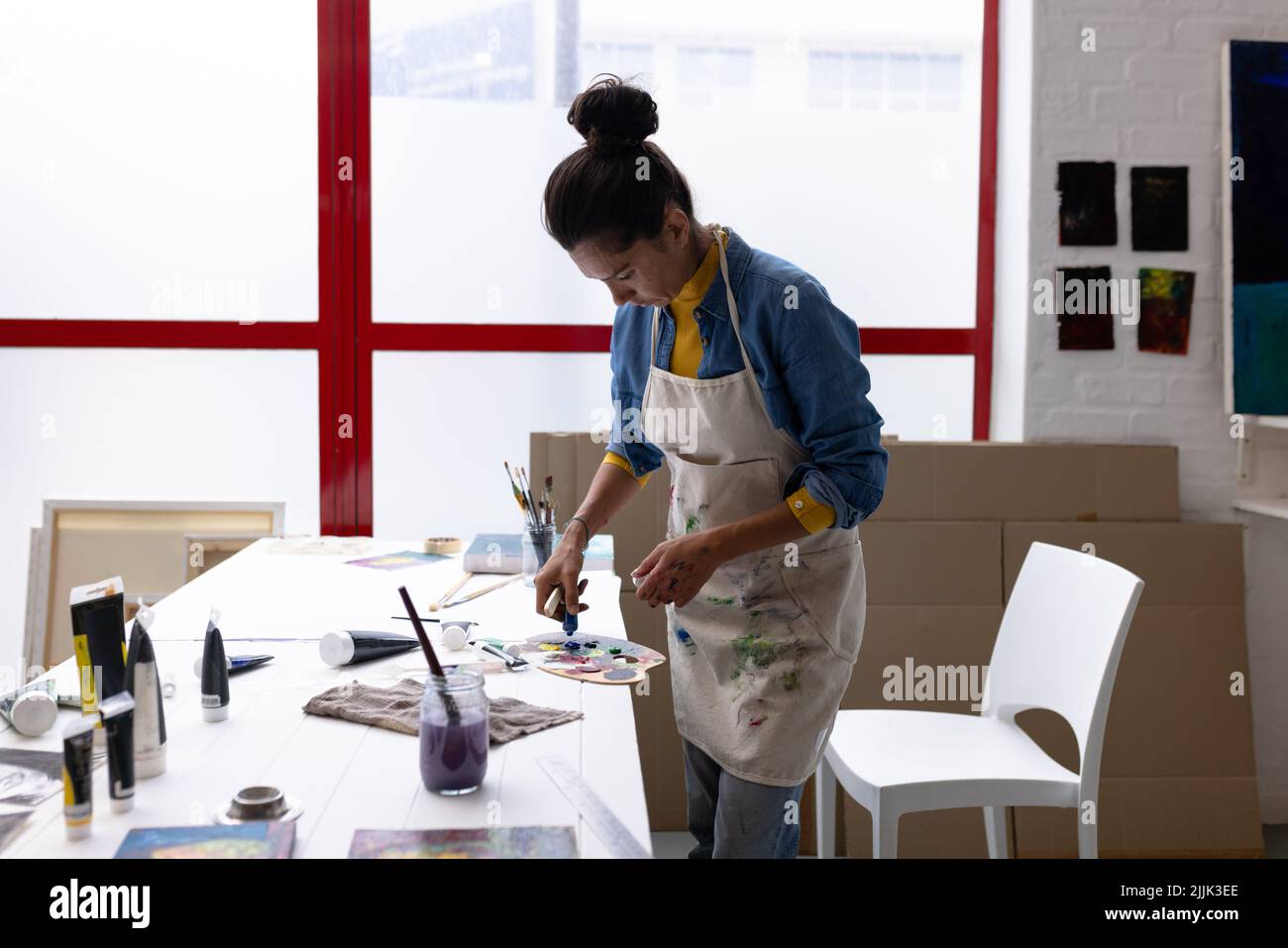 Image of biracial female artist working in studio Stock Photo - Alamy