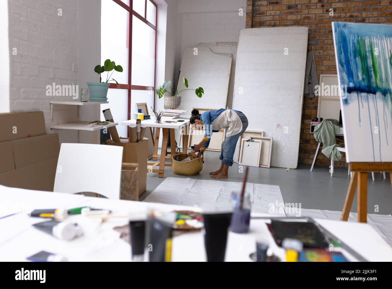 Image of biracial female artist working in studio Stock Photo - Alamy
