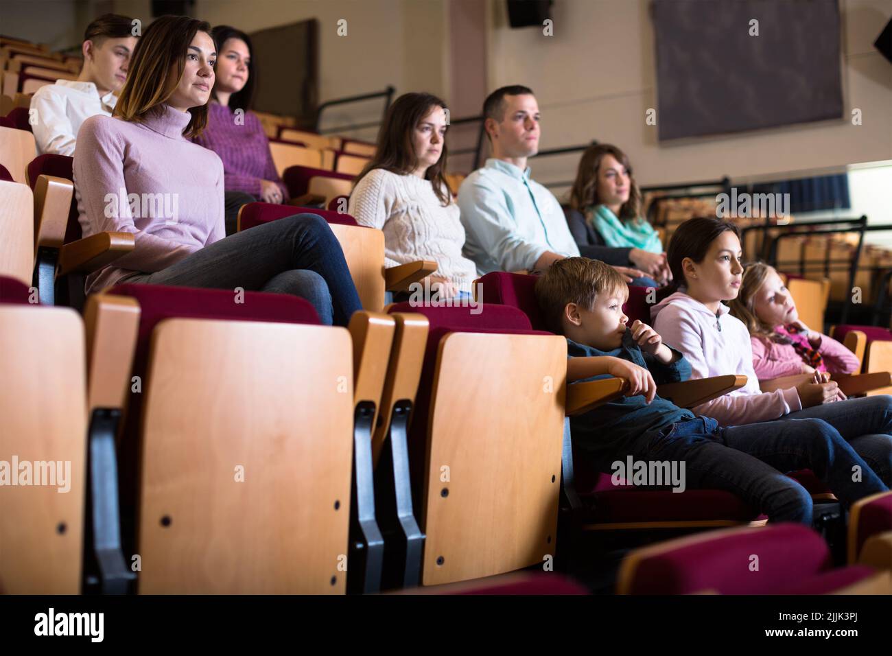 A group of people audience attending movie night Stock Photo - Alamy
