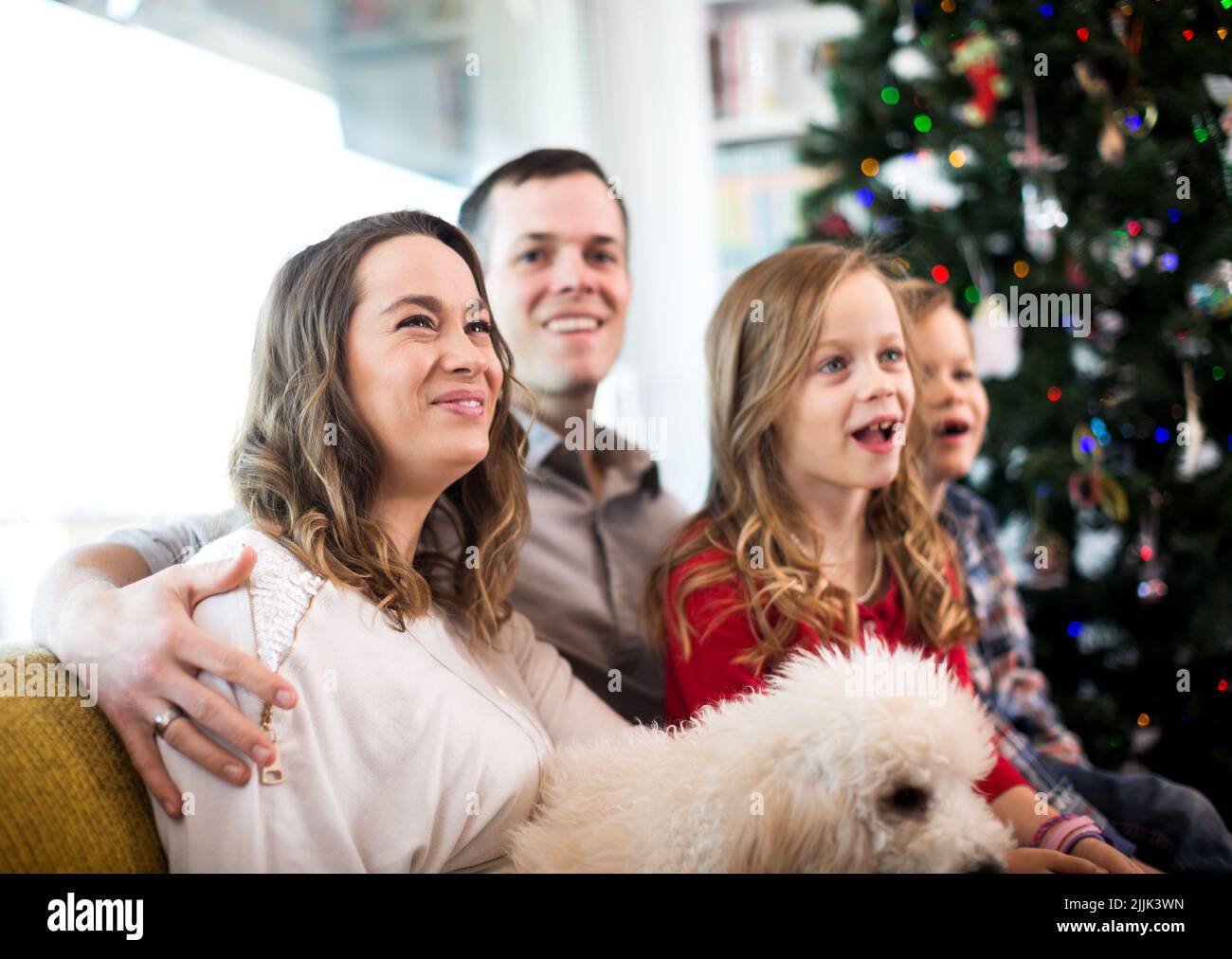 Parents and children happy to spend Christmas together Stock Photo - Alamy