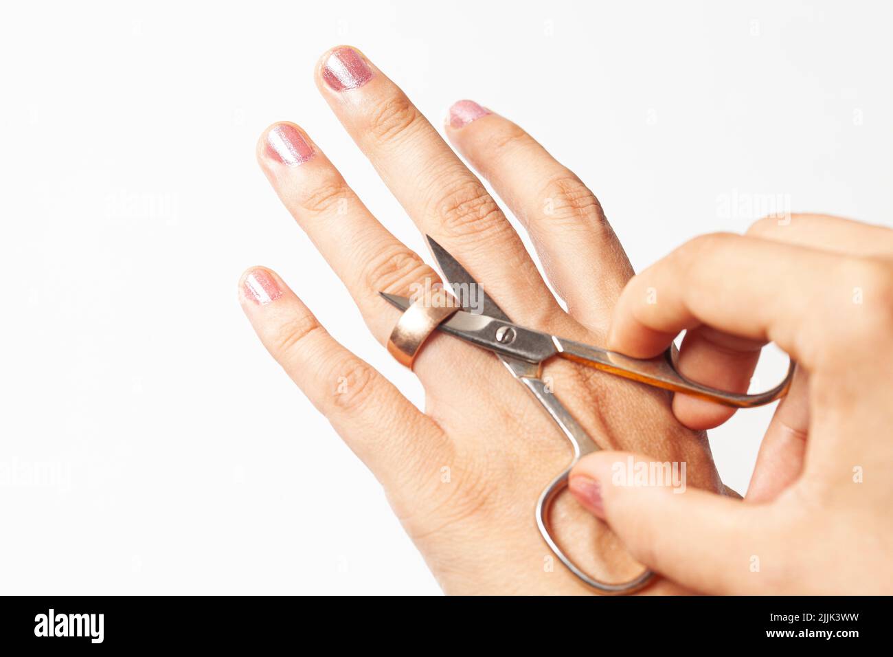 woman's hand cuts an engagement ring with scissors Stock Photo - Alamy