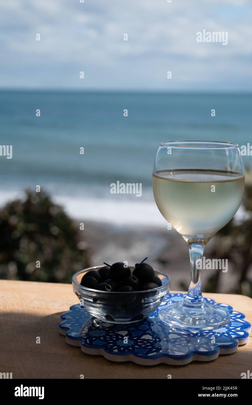 Spanish dry rueda white wine and black olives tapas served on beach ...
