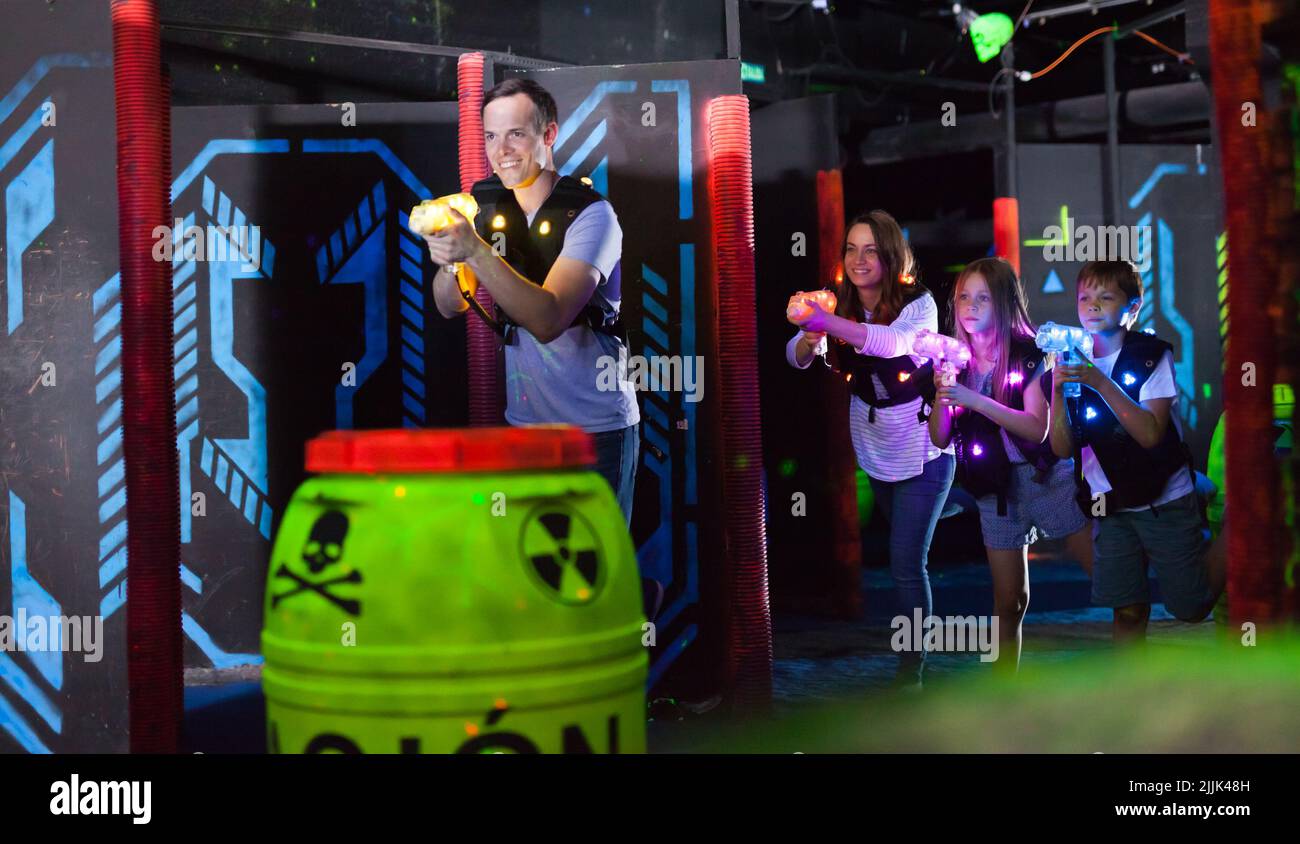 Kids and adults on lasertag arena Stock Photo - Alamy