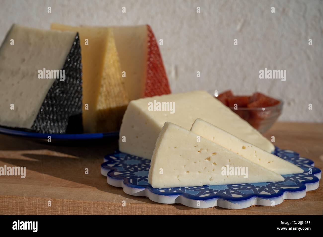 Spanish hard manchego, cow, sheep and goat cheeses served outdoor with ...