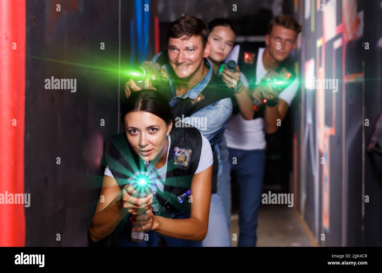 Group glad people playing laser tag game Stock Photo - Alamy
