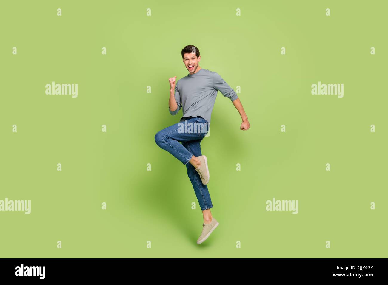 Full body photo of attractive carefree good mood man jumping in ...