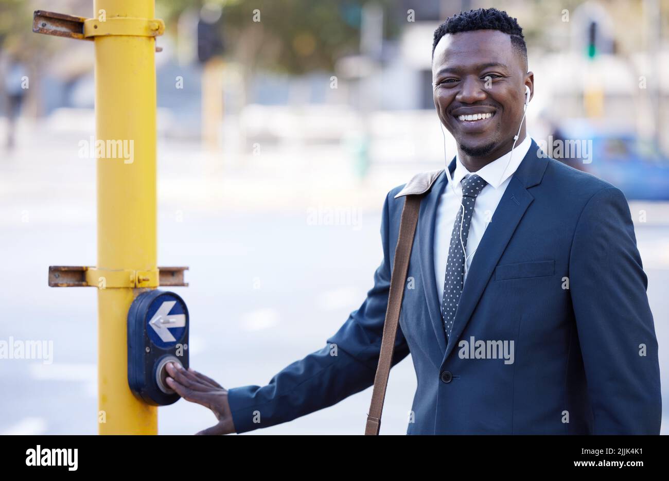 Always be cautious. a young businessman pushing a traffic light button ...
