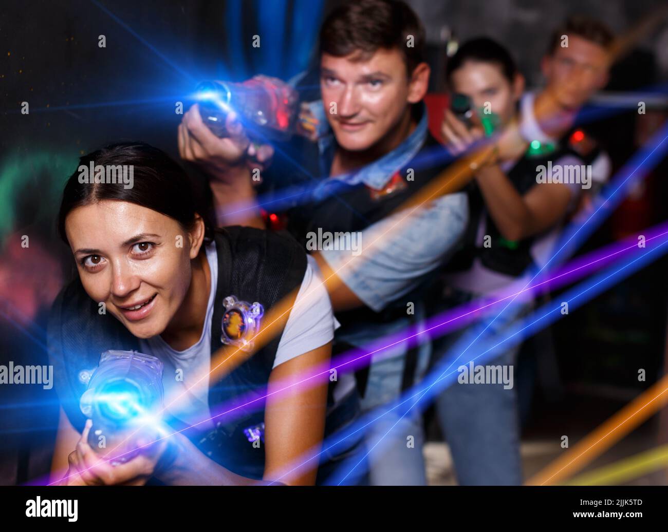 Group young people playing laser tag game Stock Photo - Alamy