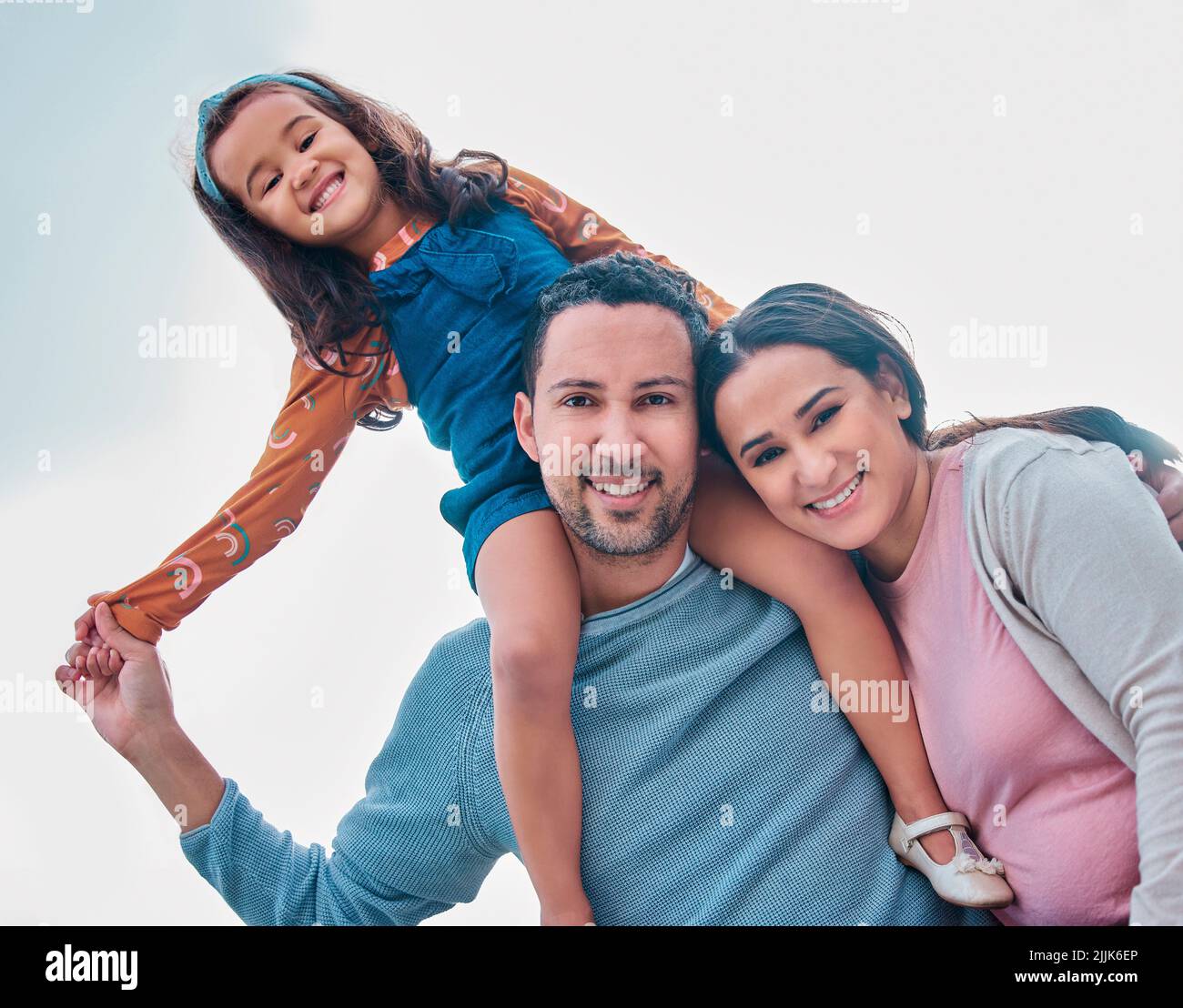 Always keep the family close. a young family spending time together in ...