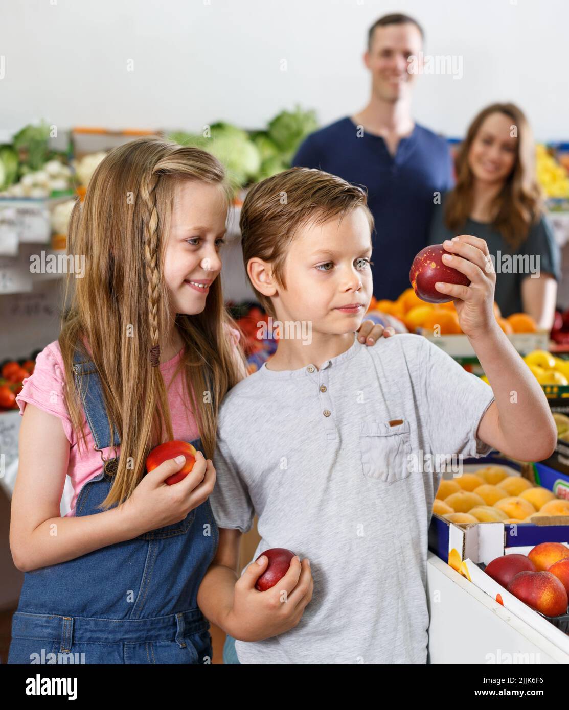 Smiling preteen children choosing fresh delicious fruits Stock Photo ...